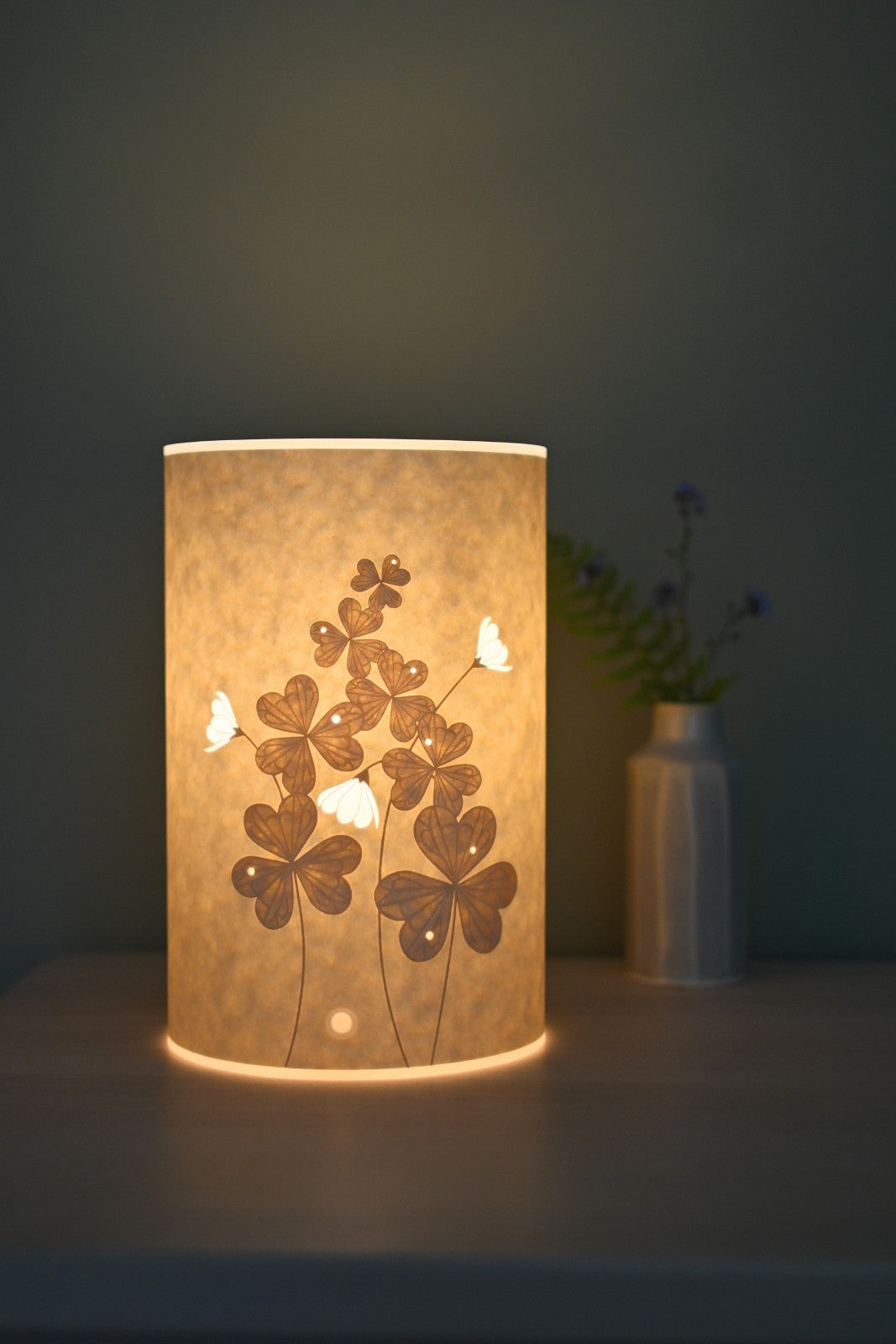 Glowing handmade parchment paper lamps with cut out nature designs by ...