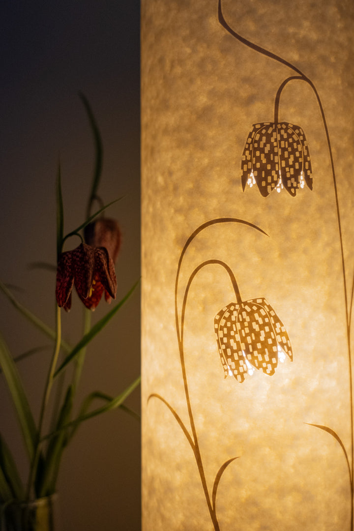 Glowing handmade parchment paper lamps with cut out nature designs by ...