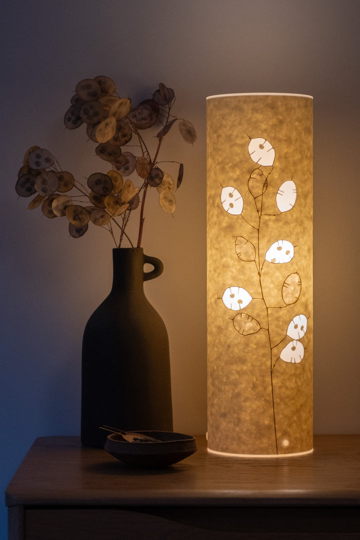 Glowing handmade parchment paper lamps with cut out nature designs by ...