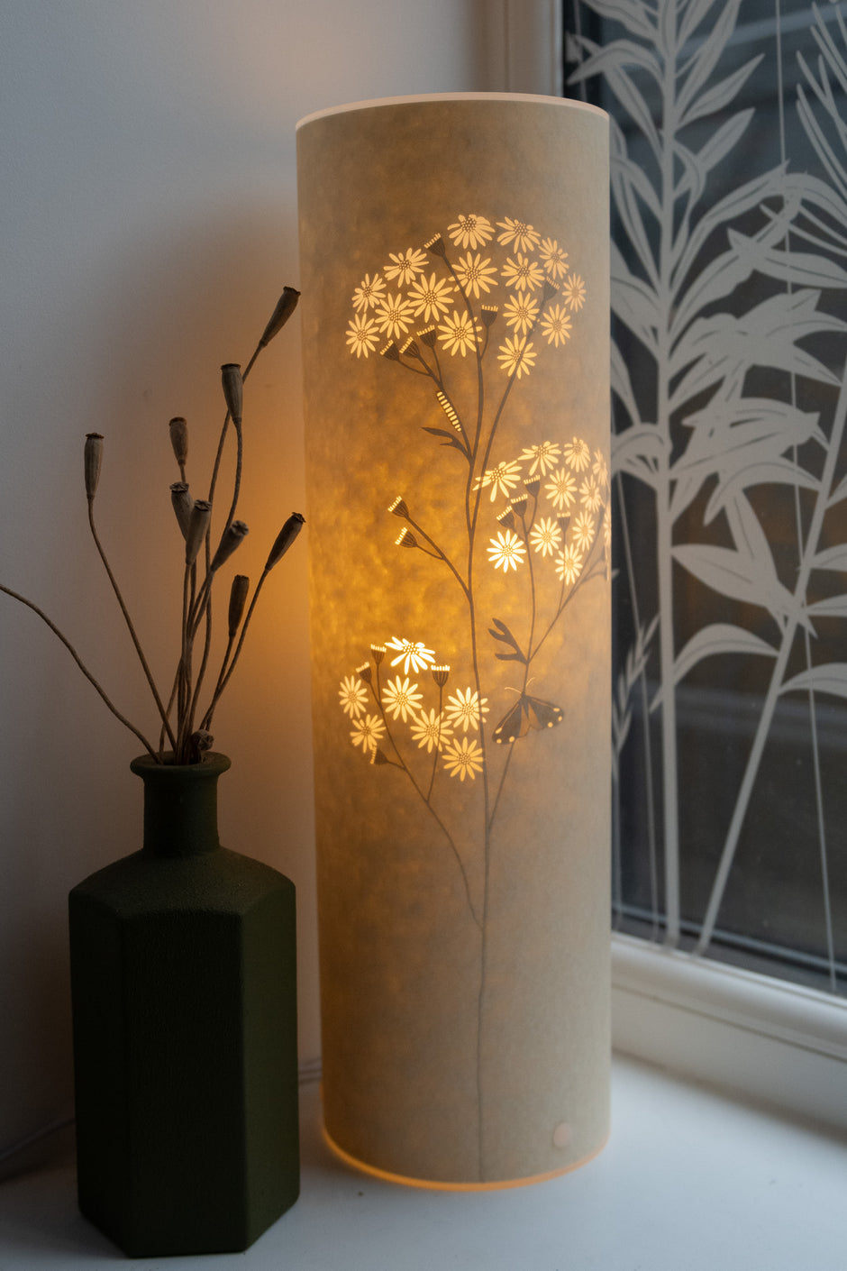 Glowing handmade parchment paper lamps with cut out nature designs by ...