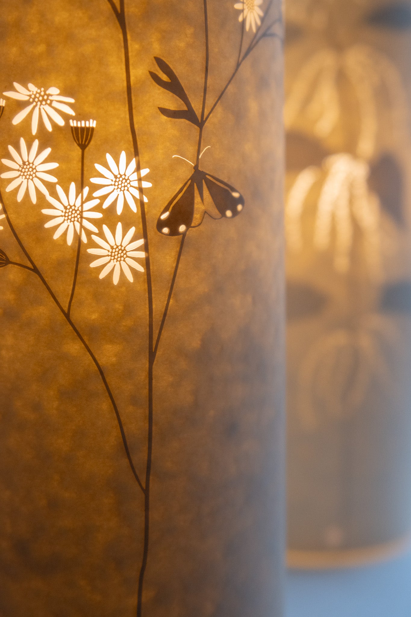 Glowing handmade parchment paper lamps with cut out nature designs by ...