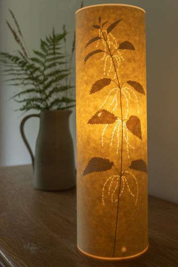 Glowing handmade parchment paper lamps with cut out nature designs by ...
