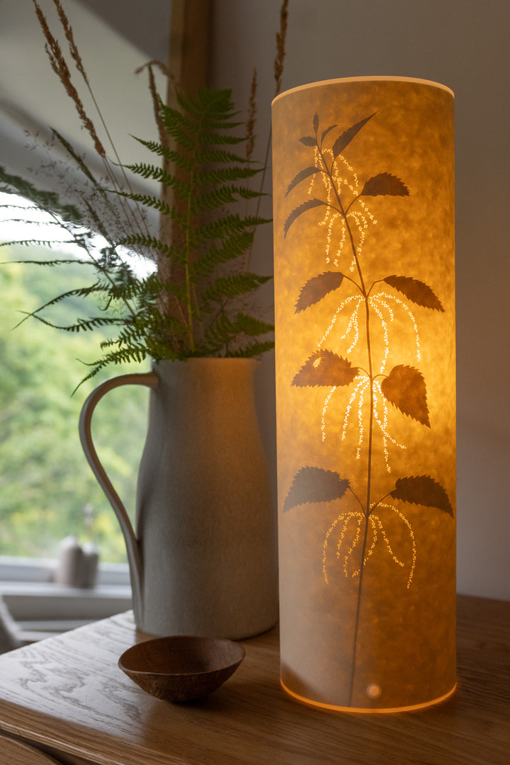 Glowing handmade parchment paper lamps with cut out nature designs by ...