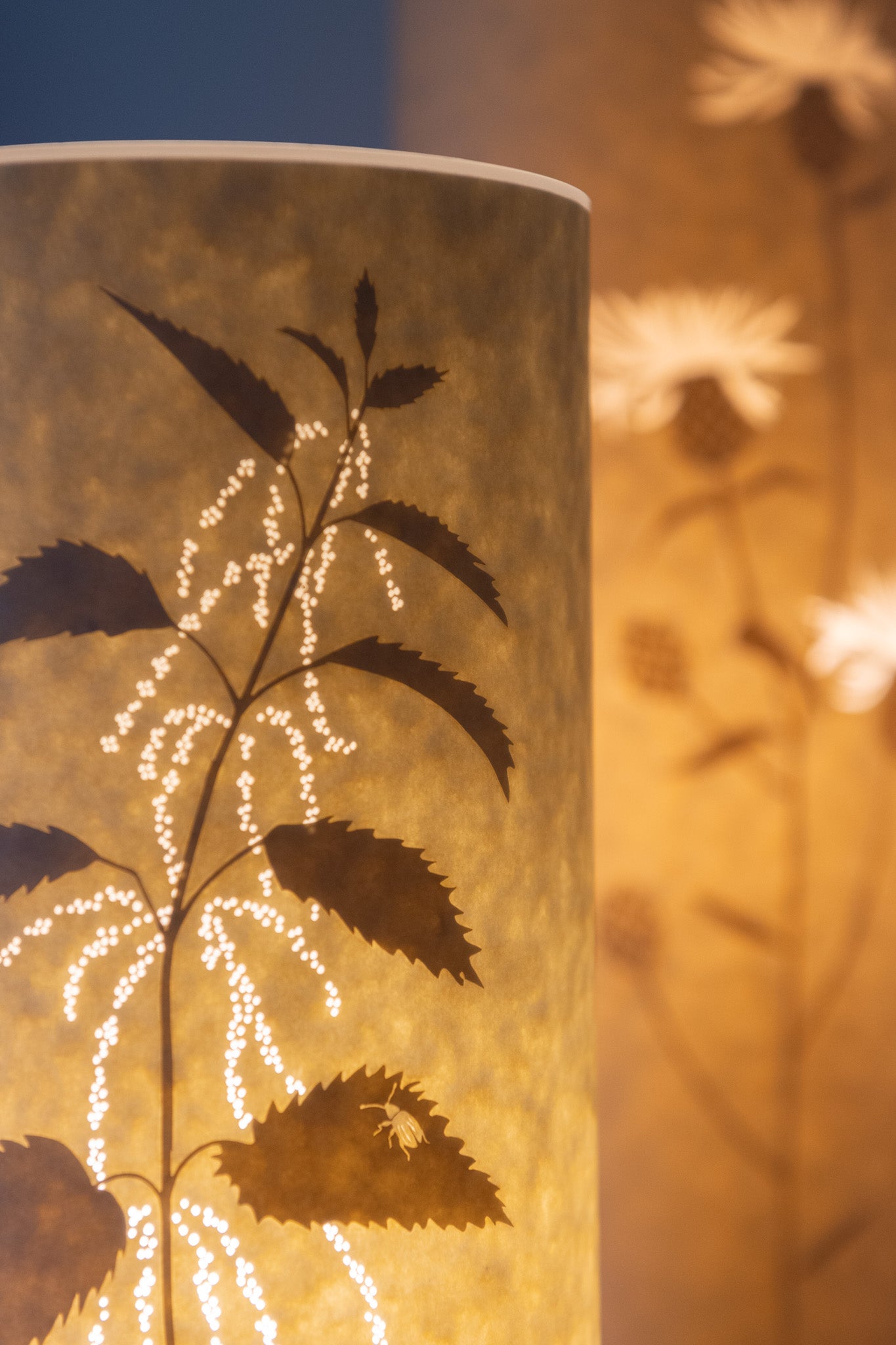Glowing handmade parchment paper lamps with cut out nature designs by ...