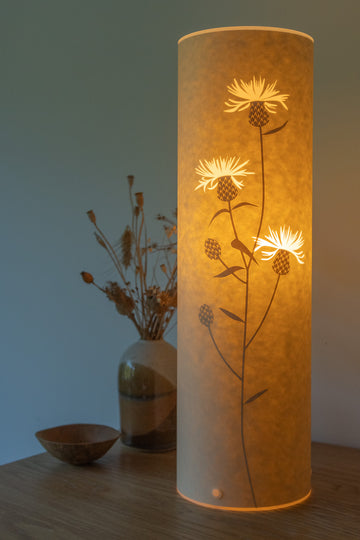 Glowing handmade parchment paper lamps with cut out nature designs by ...