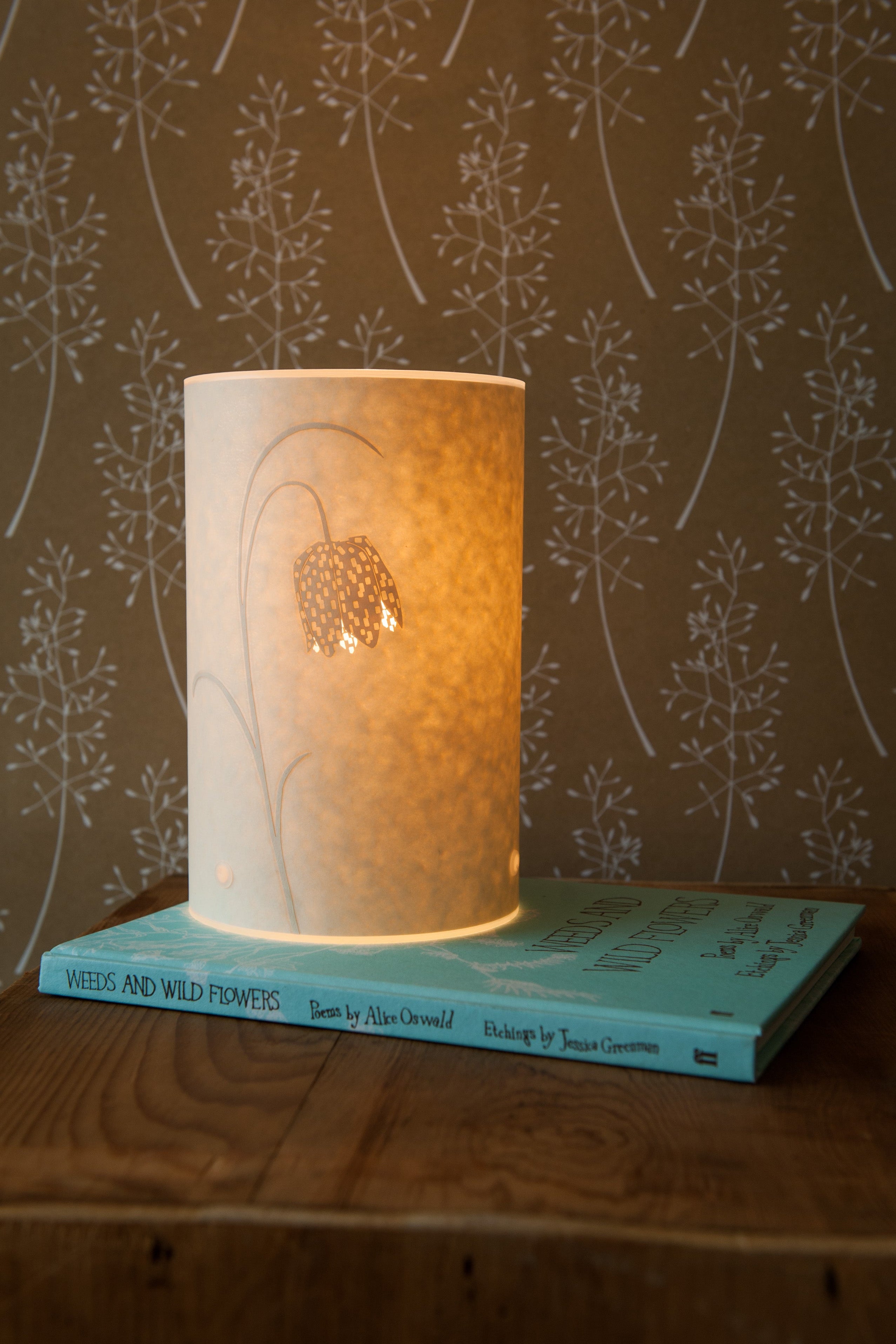 Glowing handmade parchment paper lamps with cut out nature designs by ...