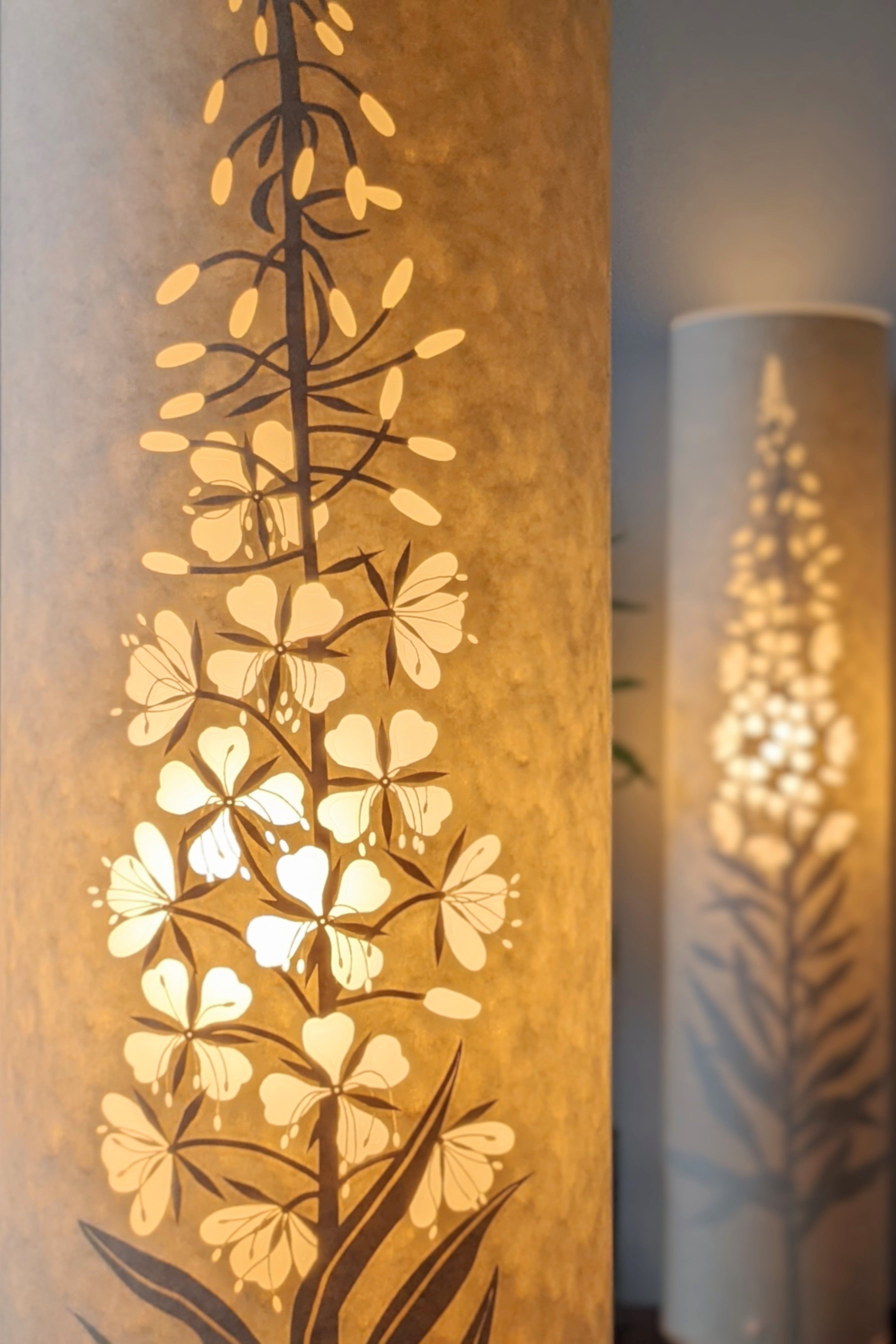 Glowing handmade parchment paper lamps with cut out nature designs by ...