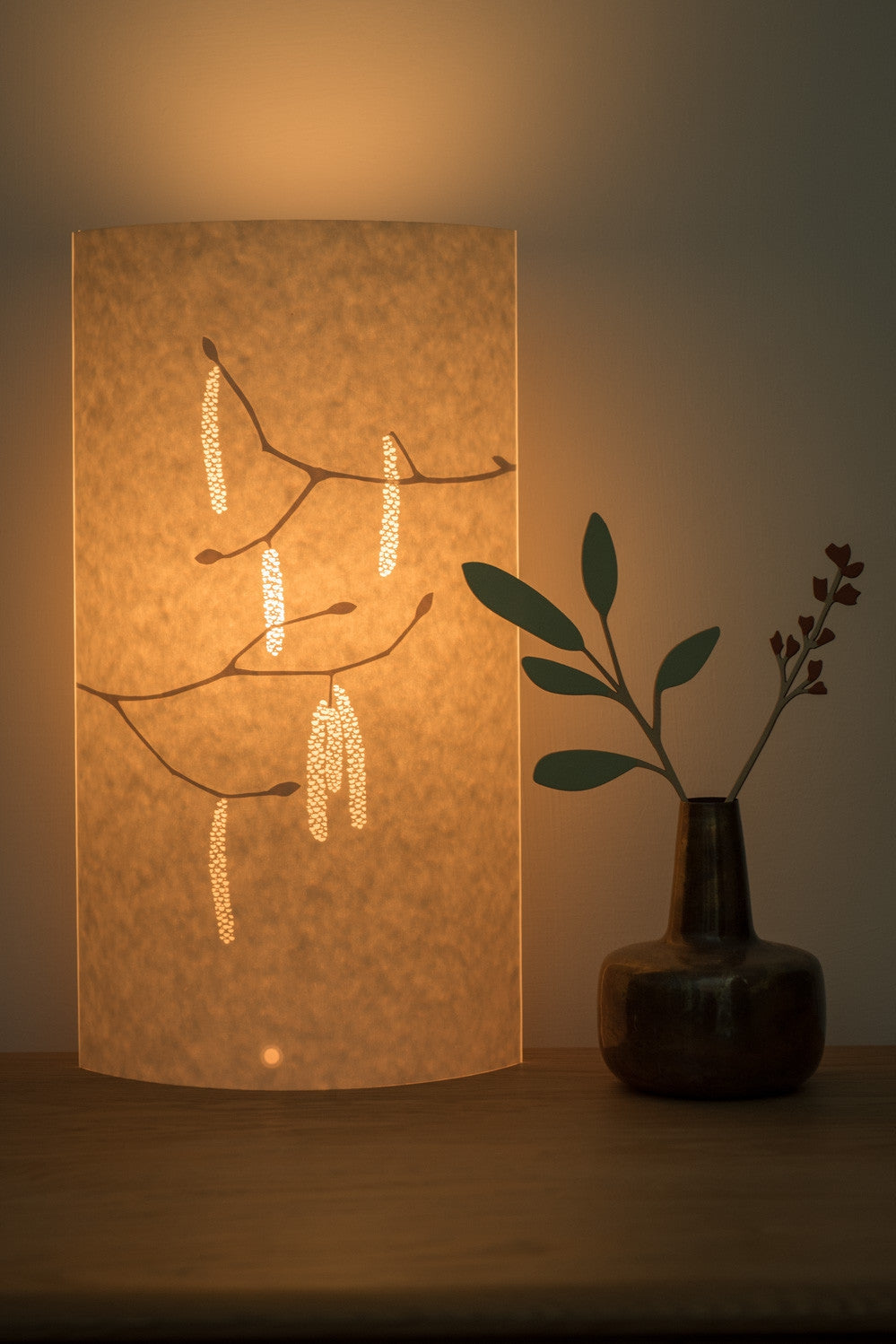 Glowing handmade parchment paper lamps with cut out nature designs by ...