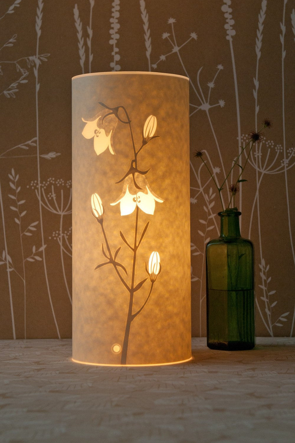 Glowing handmade parchment paper lamps with cut out nature designs by ...