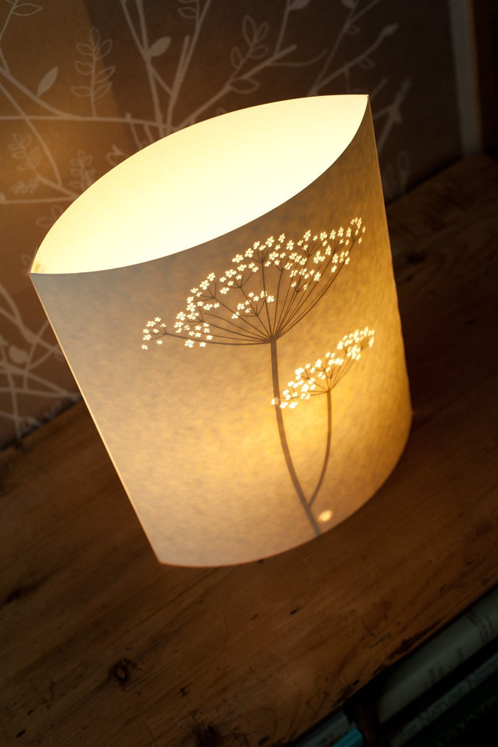 Glowing handmade parchment paper lamps with cut out nature designs by ...
